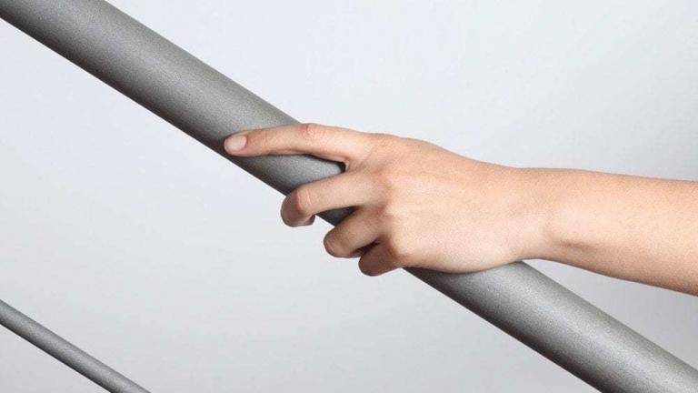 Woman hand using a railing to go upstairs - Aluminum Handrail Direct